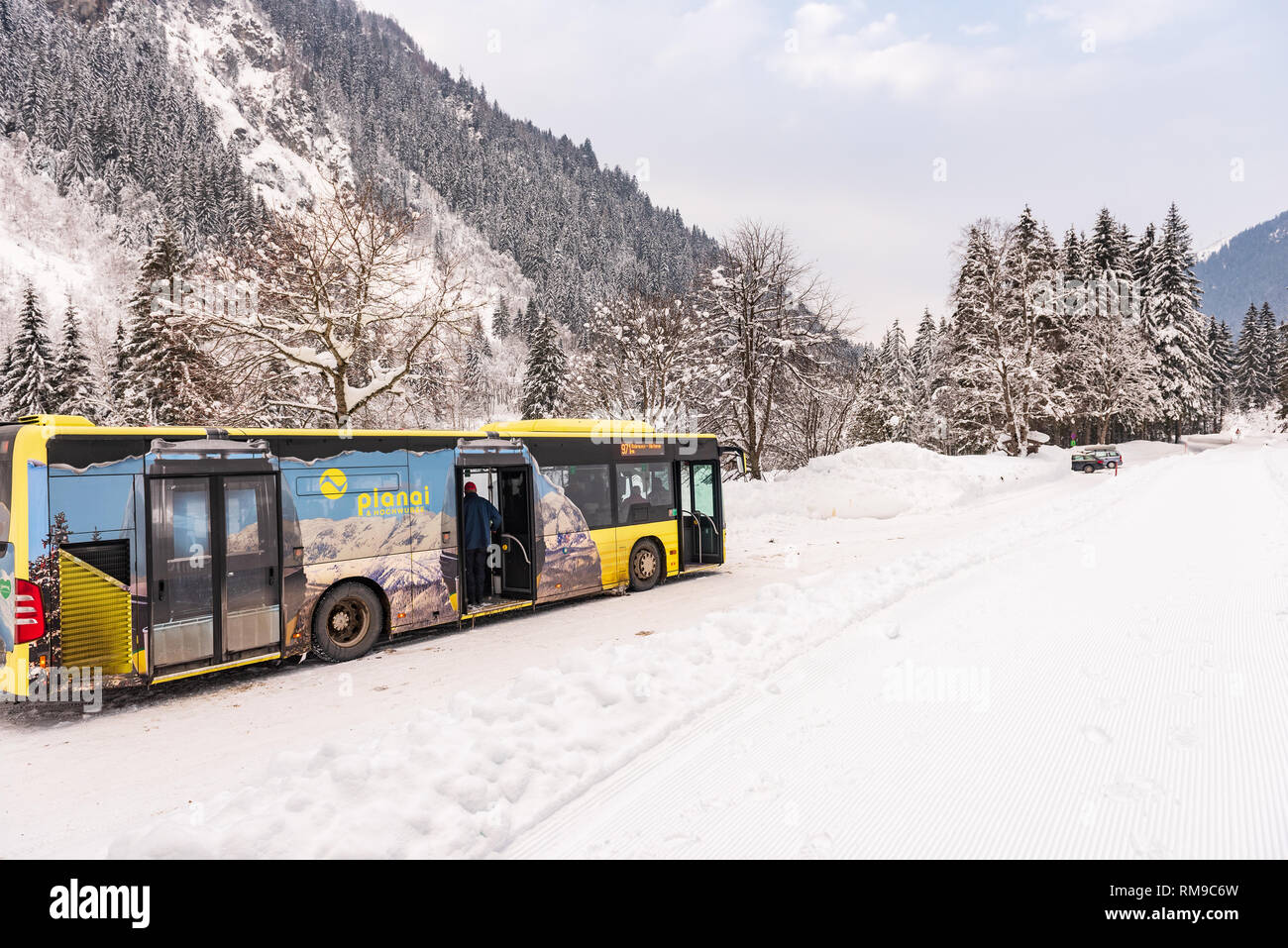 Austrian yellow Mercedes bus at bus stop in ski region Schladming ...