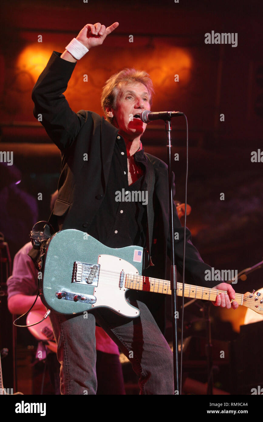 Musician John Cafferty is shown performing on stage during a "live ...
