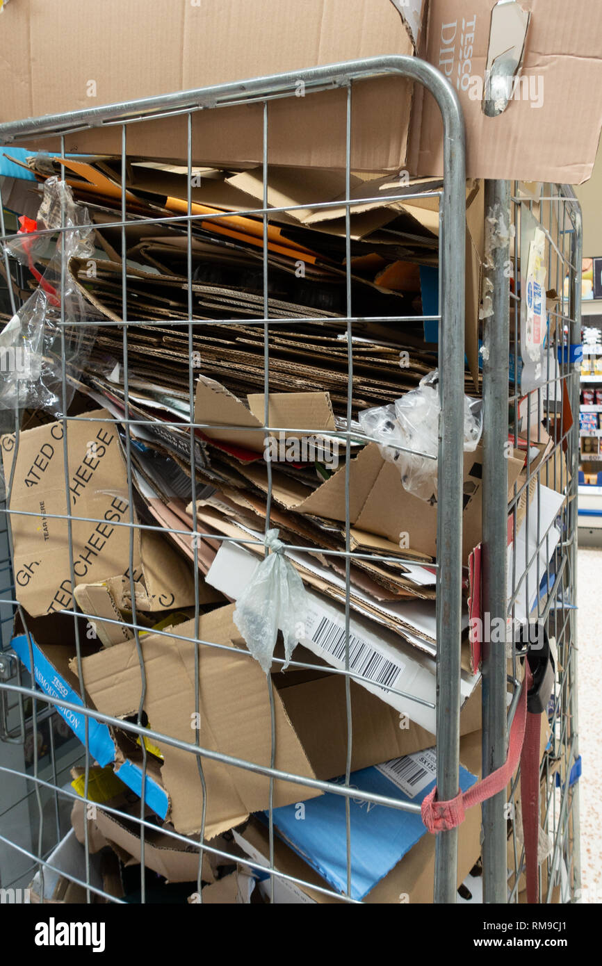 Trolly full of folded cardboard waste in the aisles of a supermarket ...