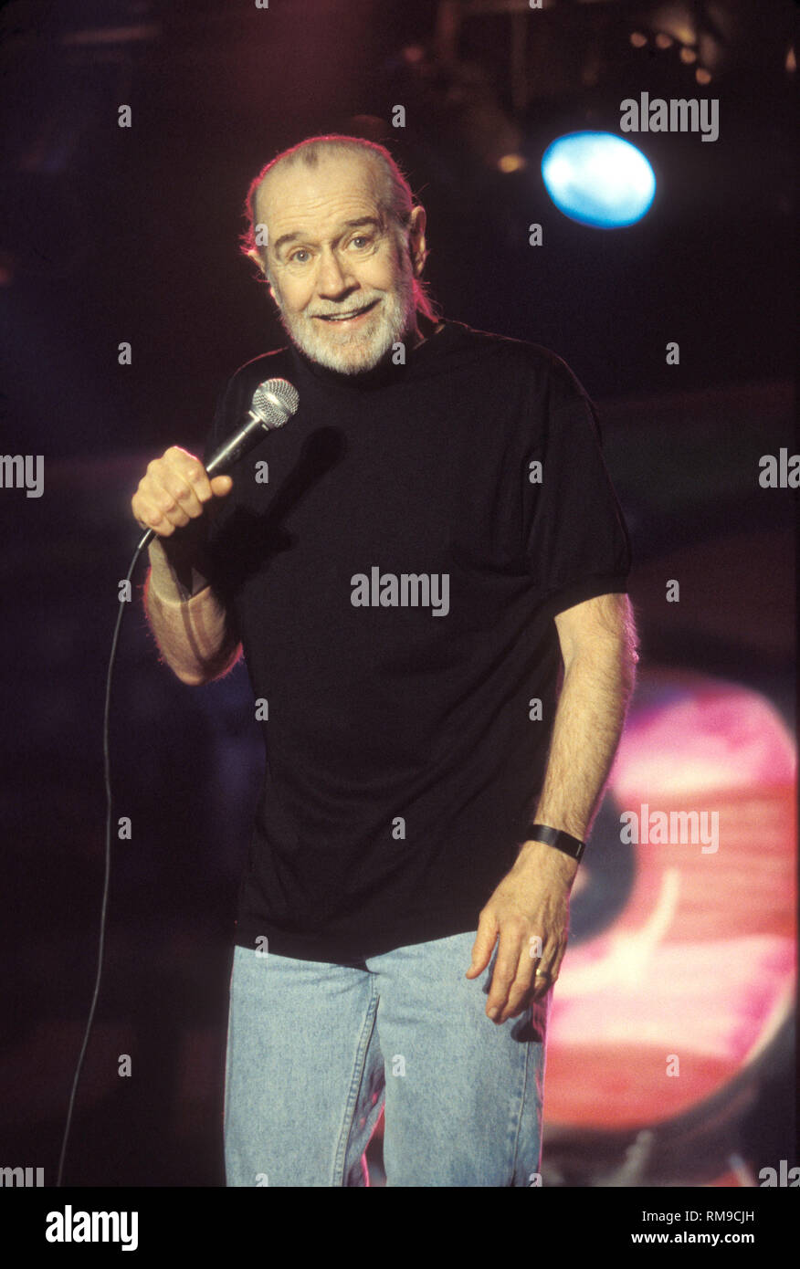 Stand up comedian, actor and author George Carlin is shown on stage during a "live" concert ...