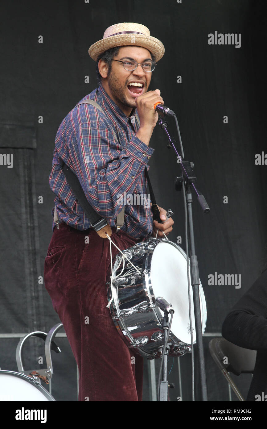 Musician Dom Flemons is shown performing on stage during a "live ...