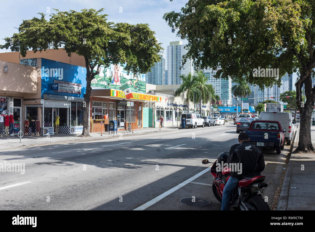 A man sits on a motorcycle by the side of SW 8th street in Miami ...