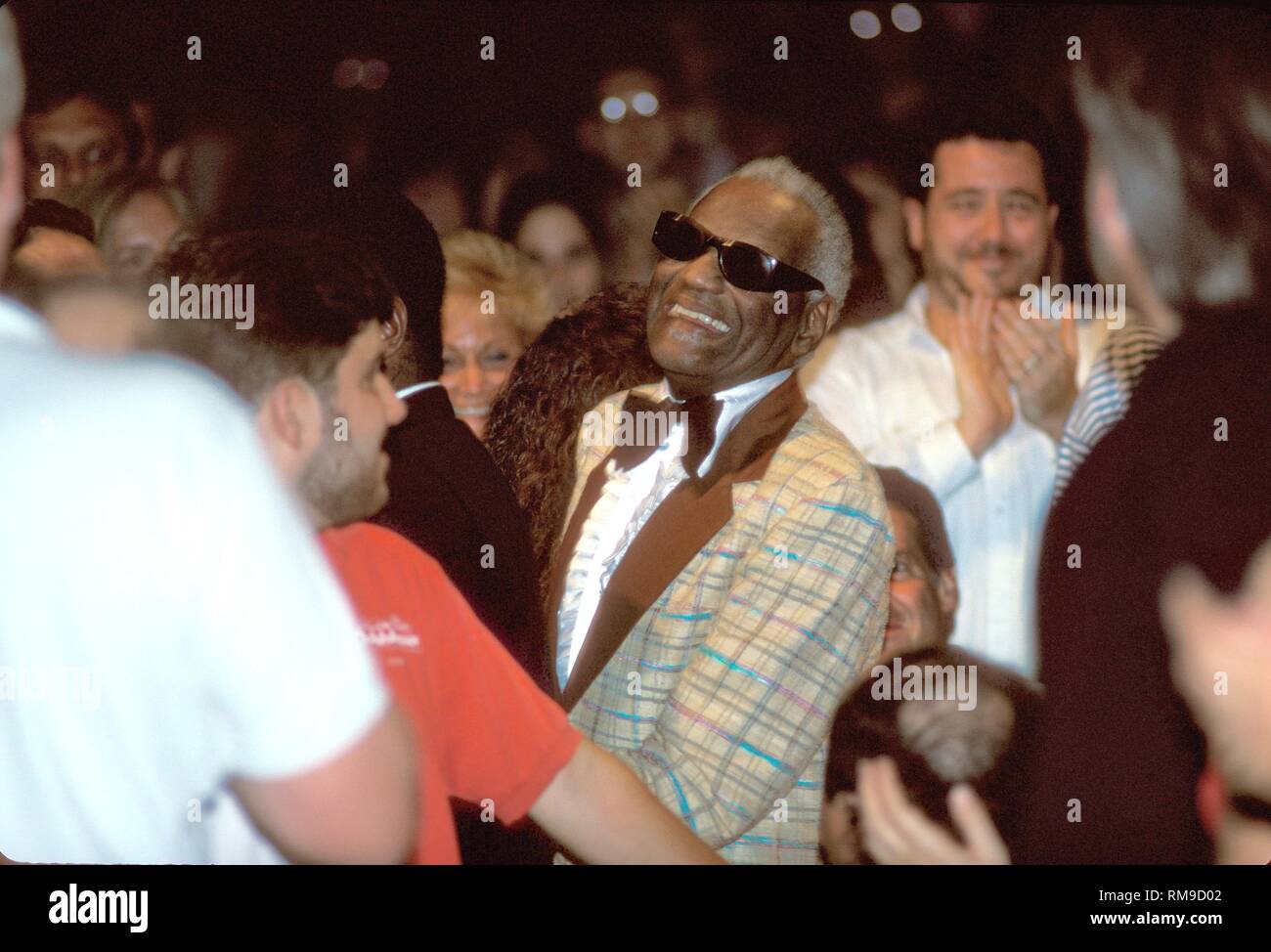 Musician Ray Charles is shown being escorted to the stage before the ...
