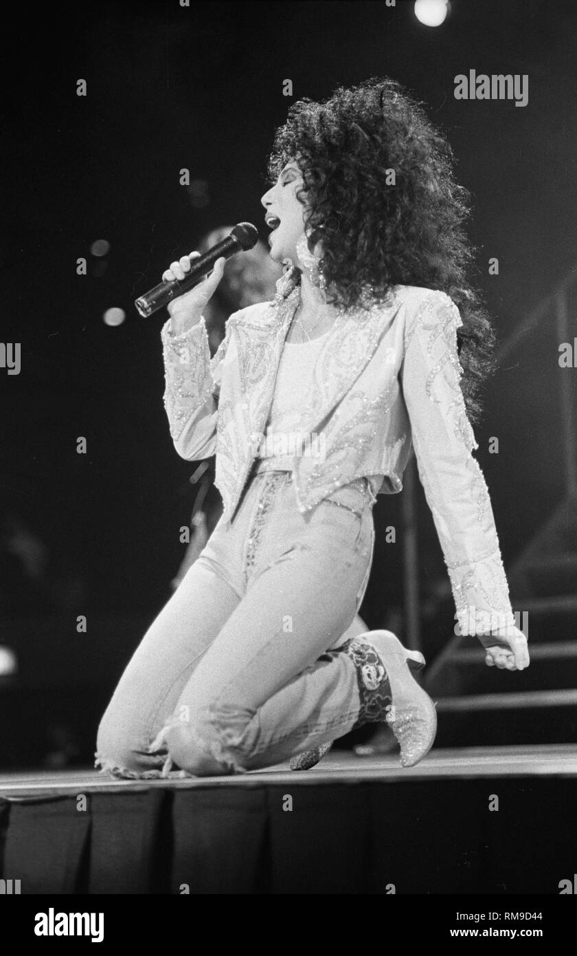 Cher, born Cherilyn Sarkisian, is shown on stage performing on stage ...