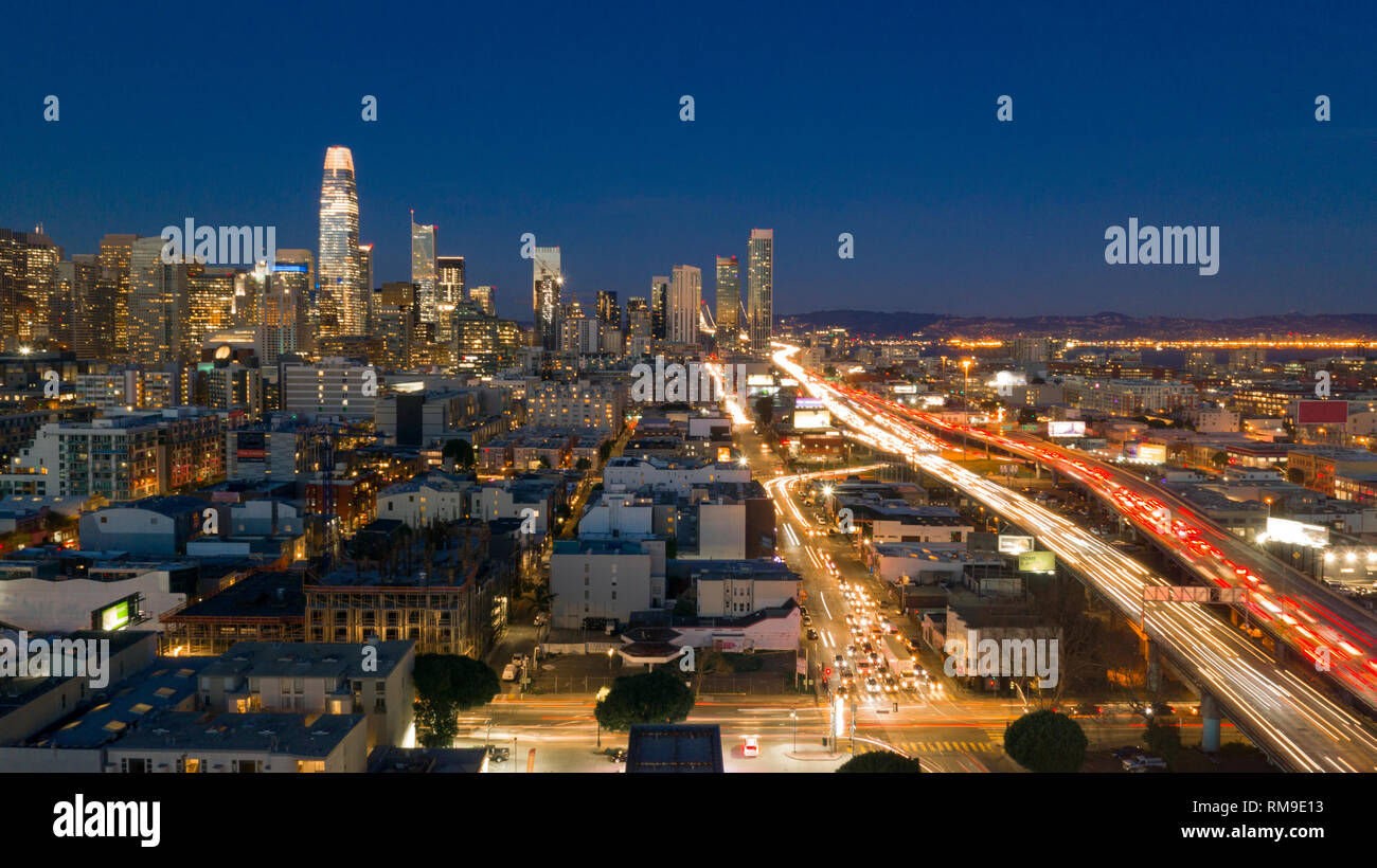 Cars go into and out of San Francisco Downtown night time rush hour ...