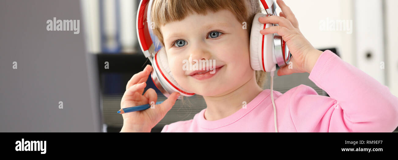 Satisfied child in headphones sitting Stock Photo - Alamy