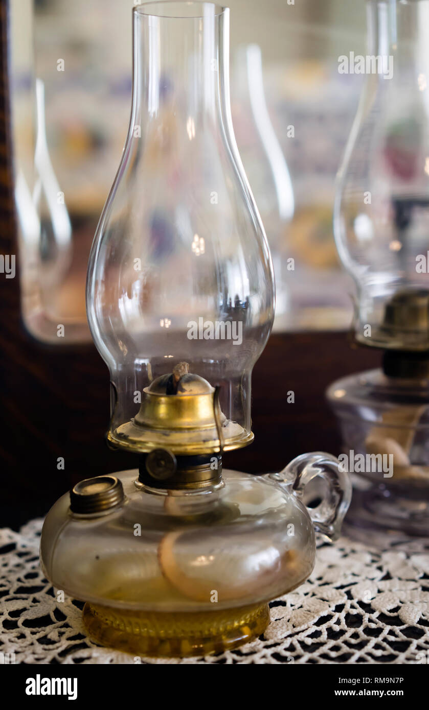 Old lamp with glass base with container for kerosene and a wick and a ...