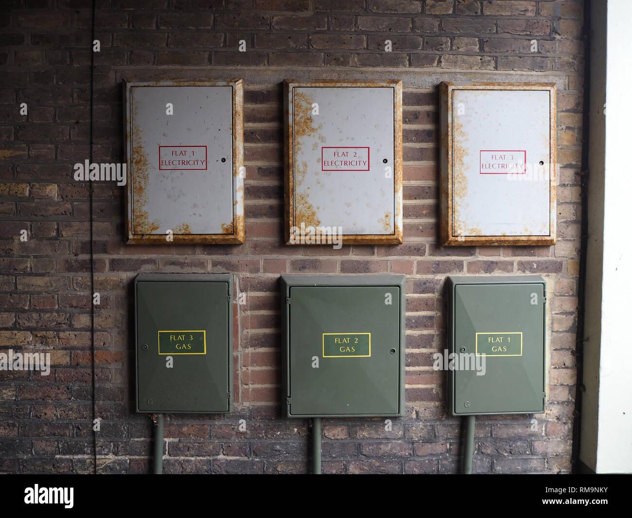 Communal flat external electricity and gas meter boxes Stock Photo - Alamy
