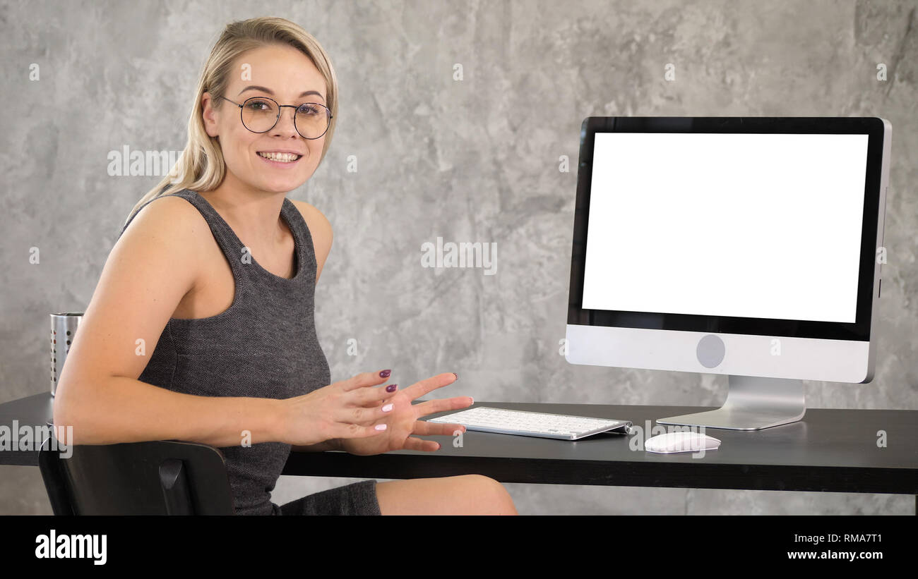 Attractive young woman wearing glasses speaking to the camera. White ...