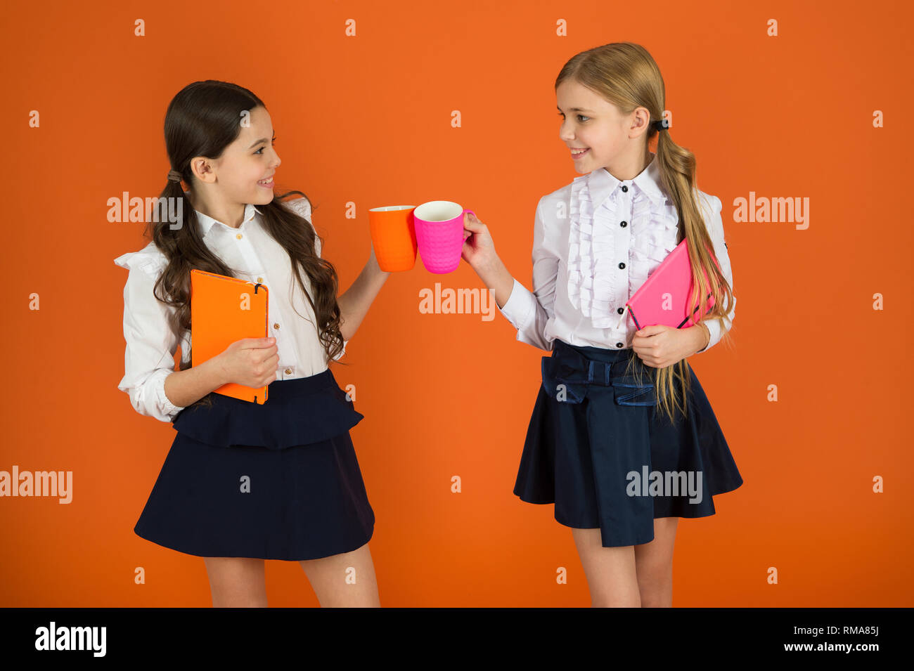 Drinking tea while break. School mates relaxing with drink. Enjoy being ...