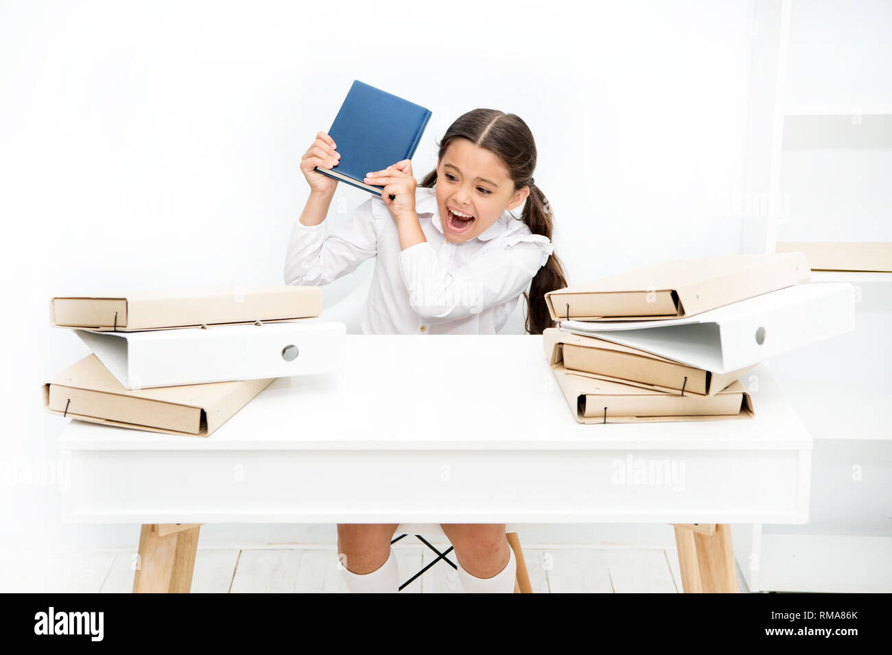 Girl bored pupil sit at desk with folders and books. Issues of formal ...