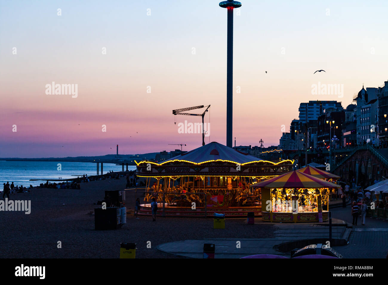 Brighton, UK - June 2018 Kids Riding the Amusement Park Carousel along ...