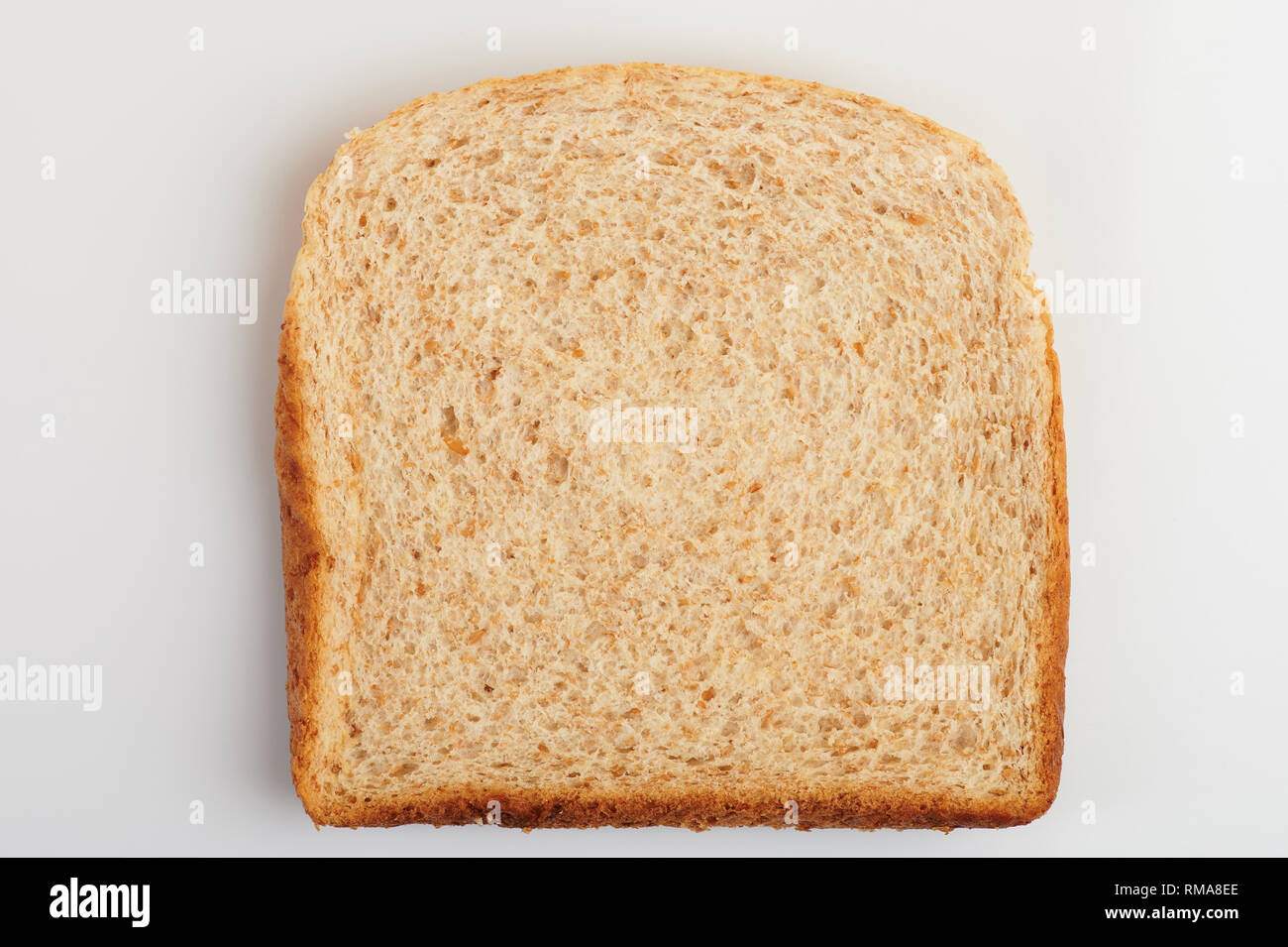 One slice of wholemeal bread isolated on white background Stock Photo ...