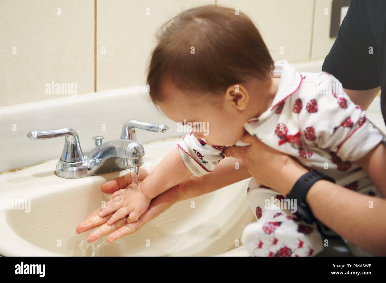 Mother teach baby wash hands in bathroom. Baby hygiene theme Stock ...