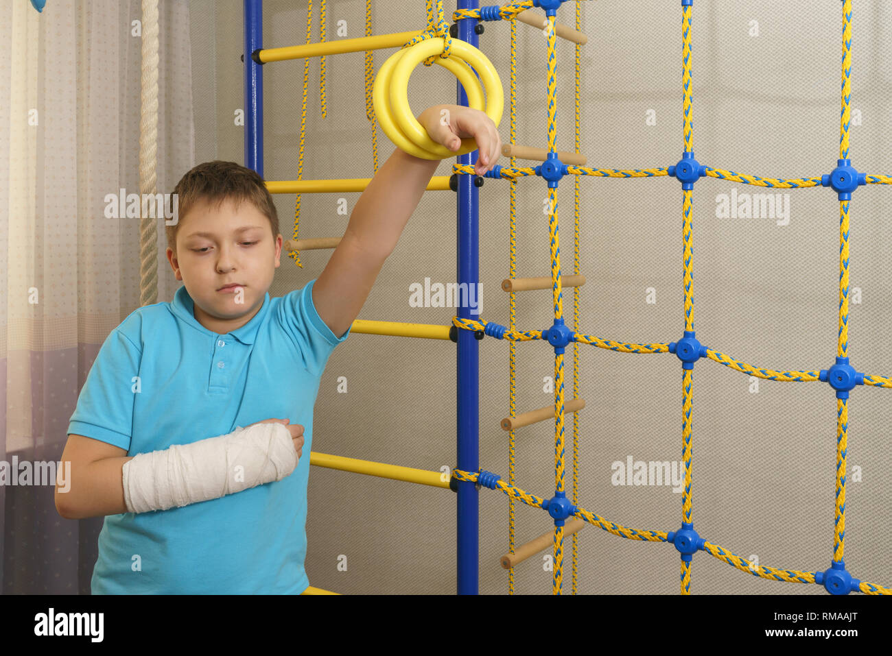 Sad child with a broken arm in the home environment . The cast on the ...