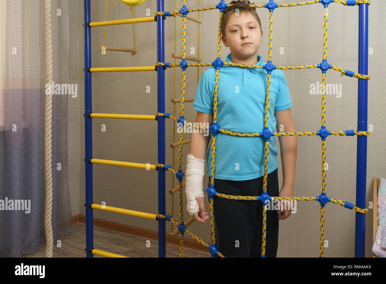 Sad child with a broken arm in the home environment . The cast on the ...