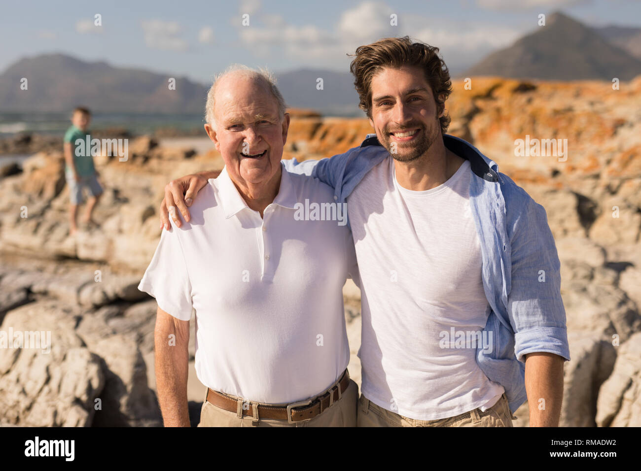 Happy father and son with arms around looking at camera Stock Photo - Alamy