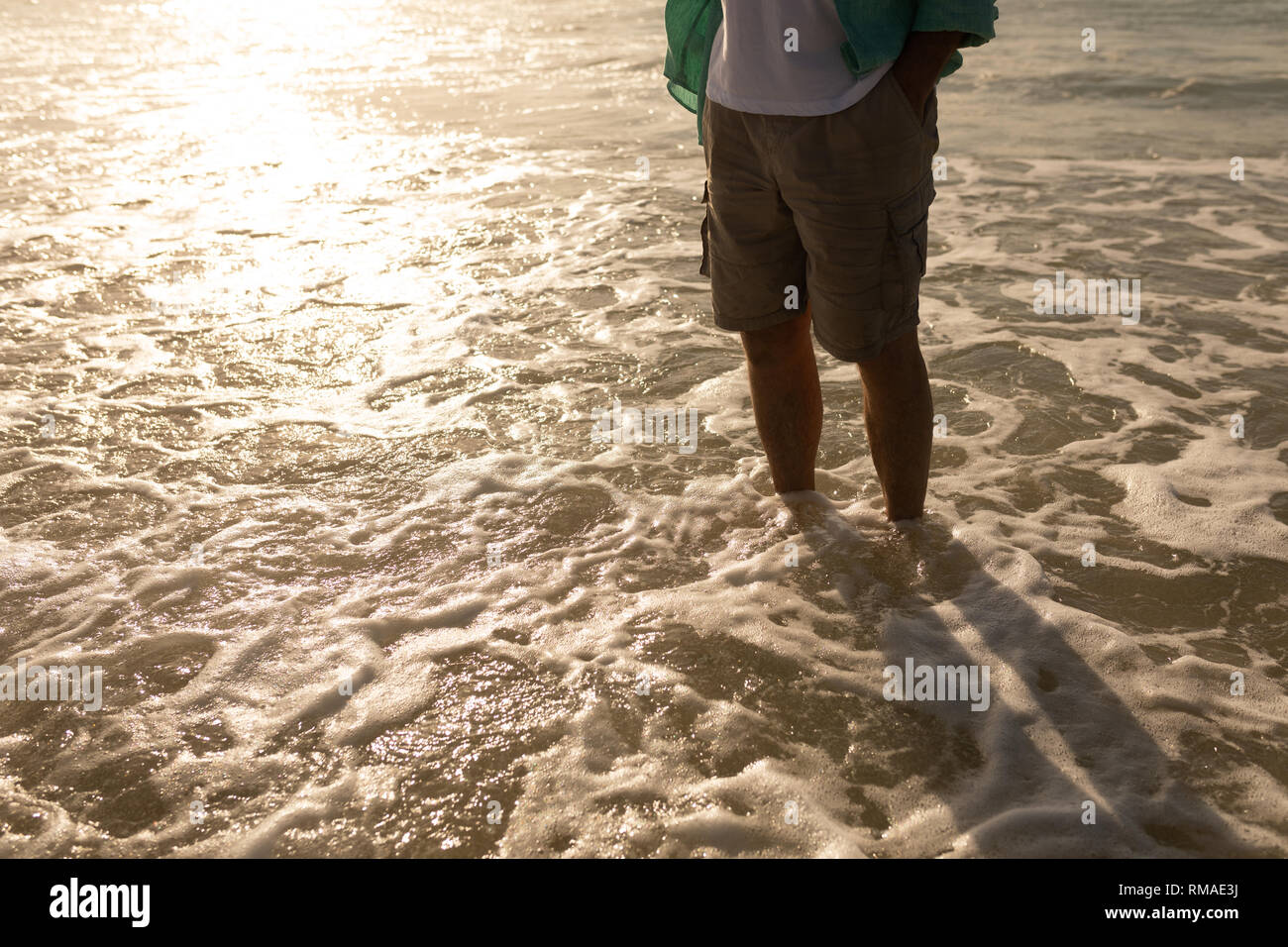 Man standing on beach sea hi-res stock photography and images - Alamy