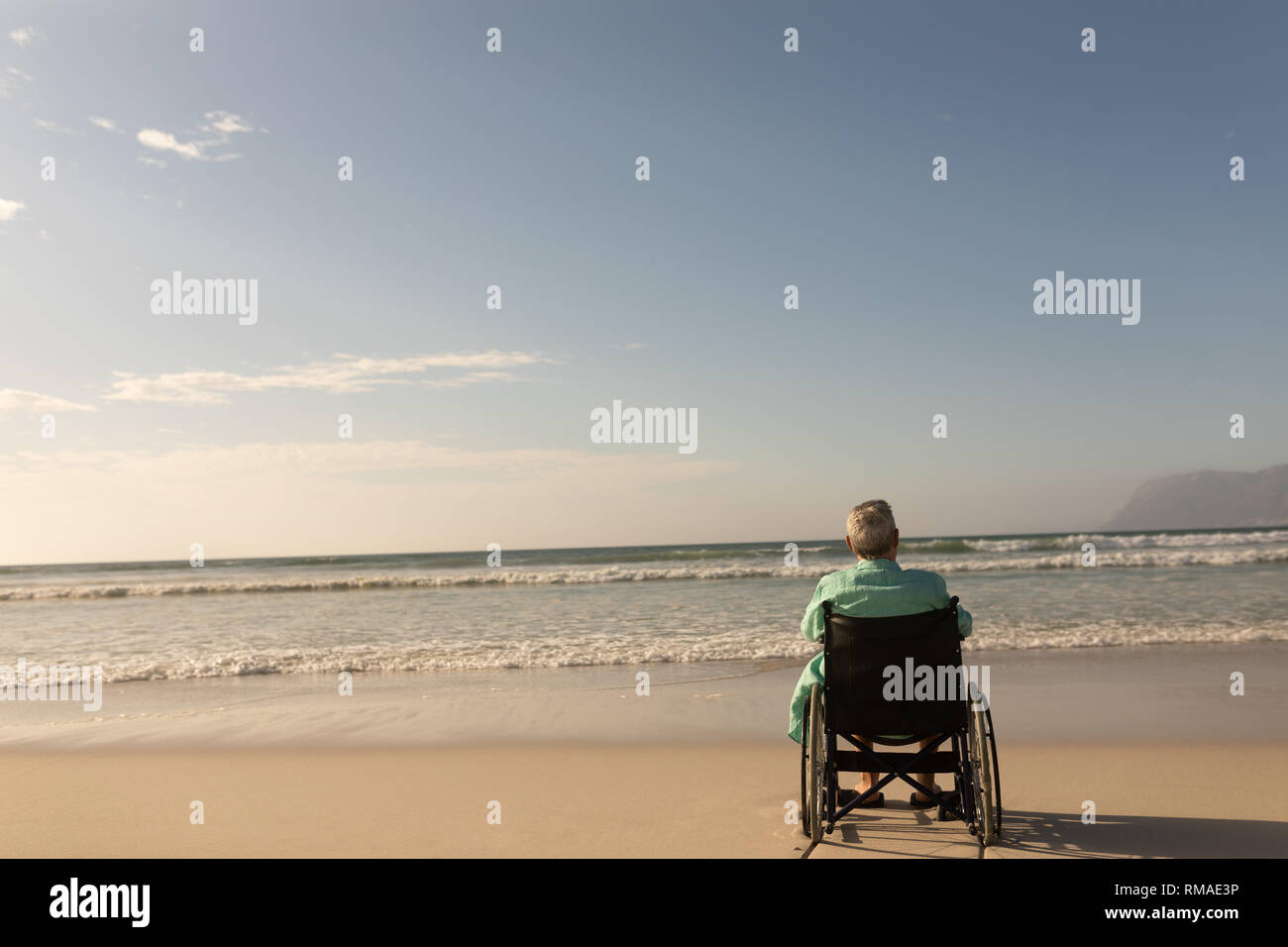 Disabled senior man looking at ocean on the beach Stock Photo - Alamy
