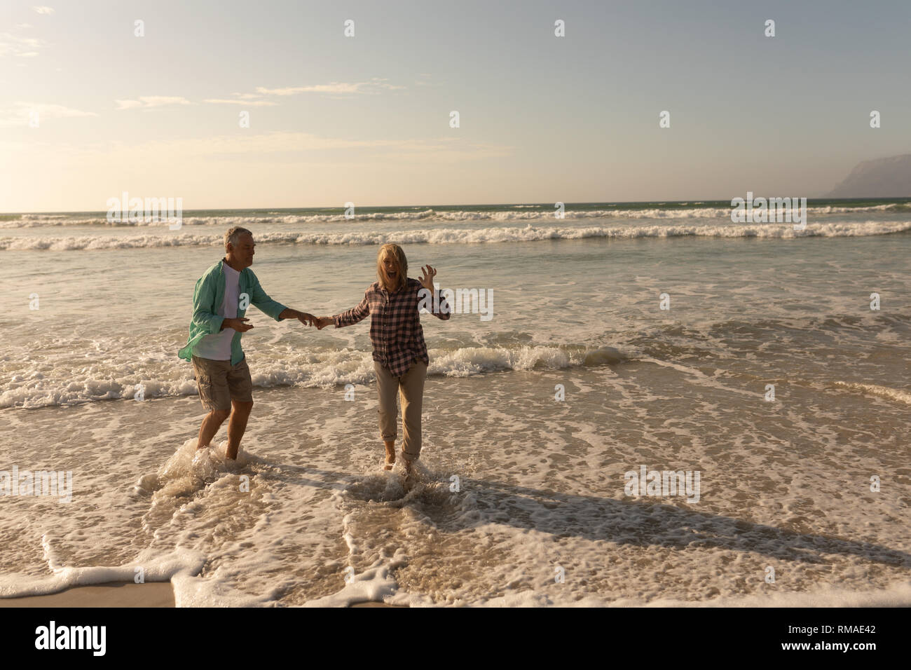 Senior couple having fun on the beach Stock Photo - Alamy