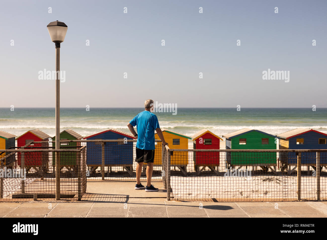 Rear view man standing railing hi-res stock photography and images - Alamy