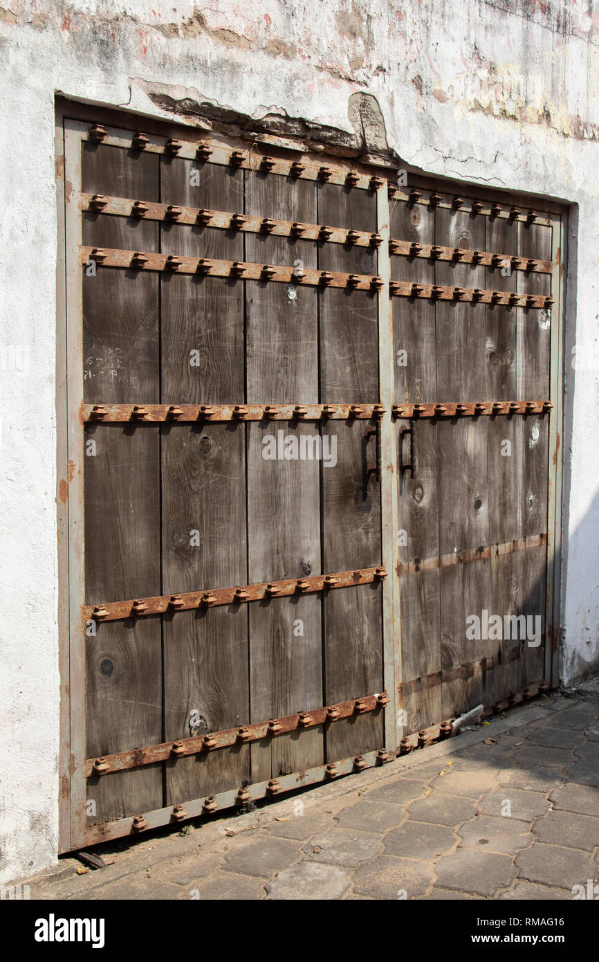 old wooden gate and a neglected facade, rusty blacksmith Stock Photo ...