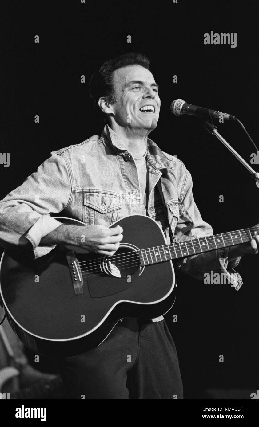 Musician John Hiatt is shown performing on stage during a "live ...