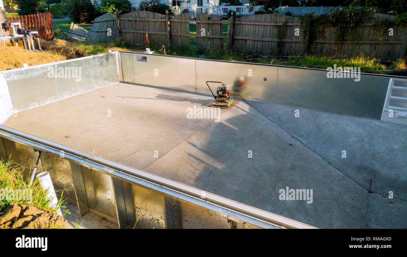Laying construction of the swimming pool in the garden of the family ...