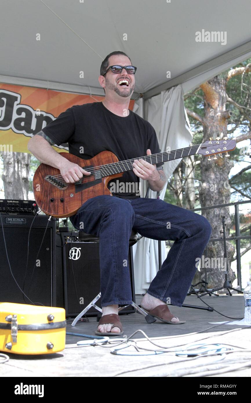 Musician Charlie Hunter is shown performing on stage during a "live ...