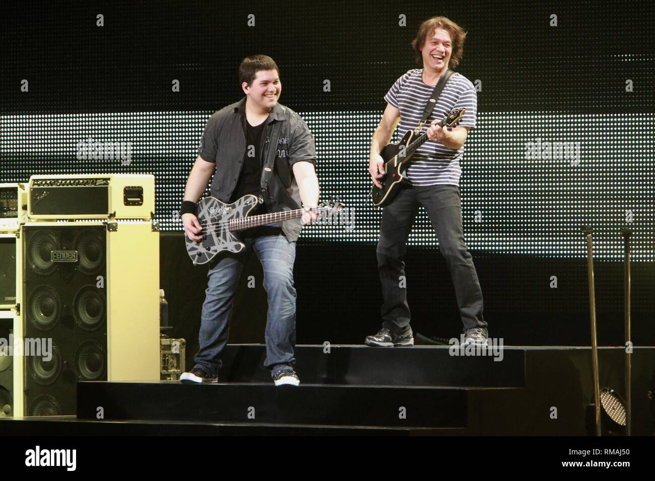 Wolfgang and Eddie Van Halen are shown performing together on stage ...