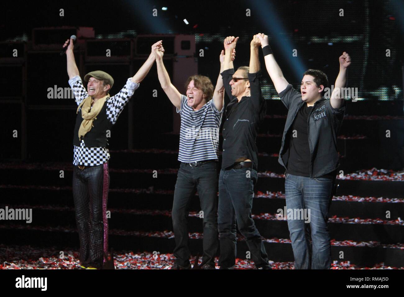 Van Halen band members are shown lined up on stage at the completion of ...