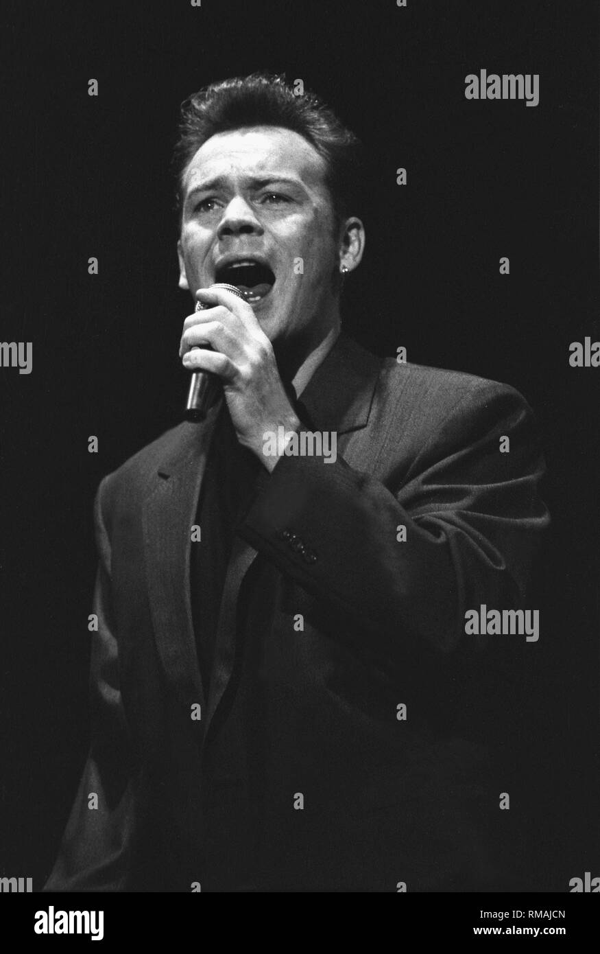 Lead singer Ali Campbell is shown performing on stage during a "live ...