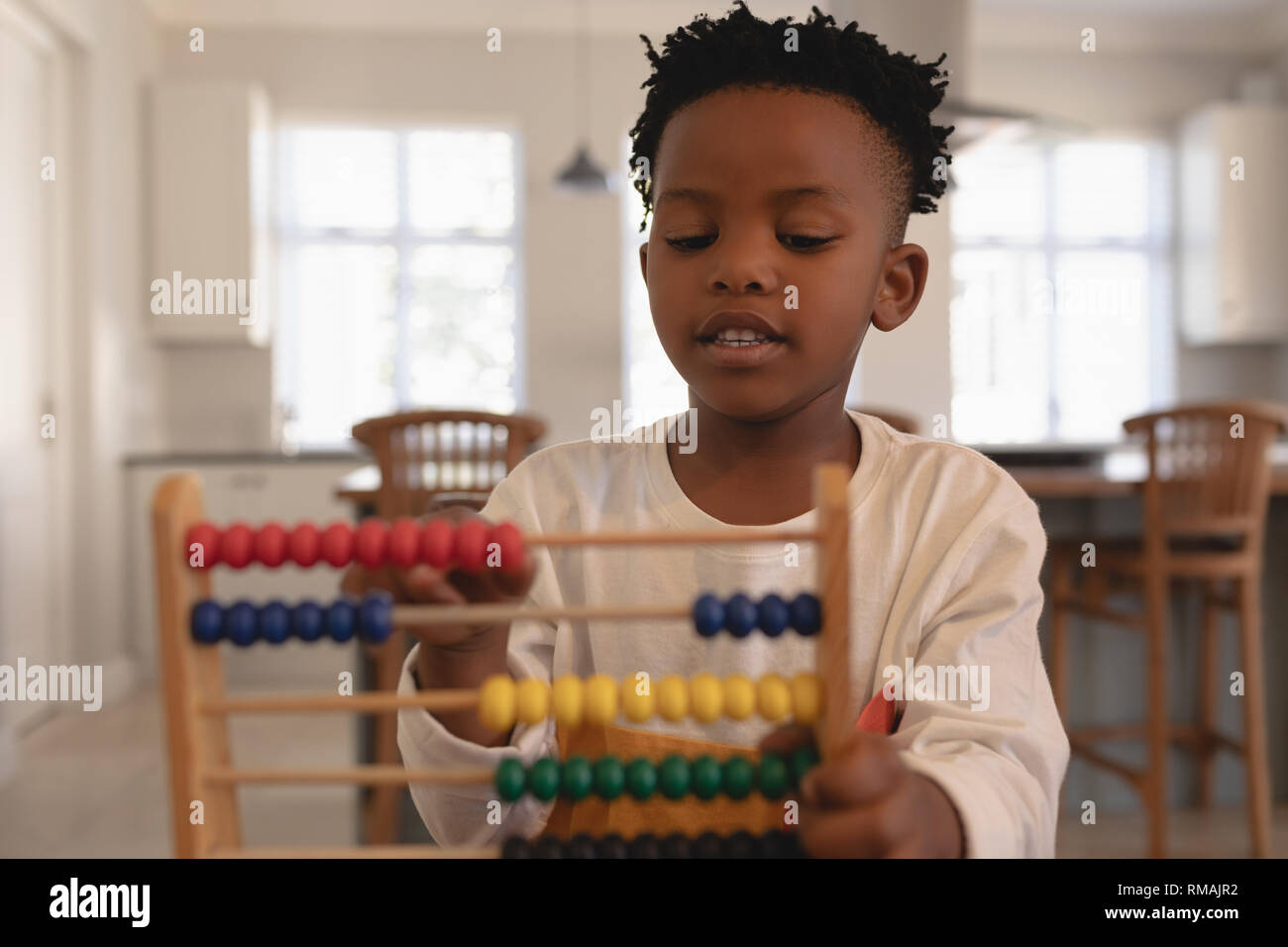 African American boy learning mathematics with abacus Stock Photo - Alamy