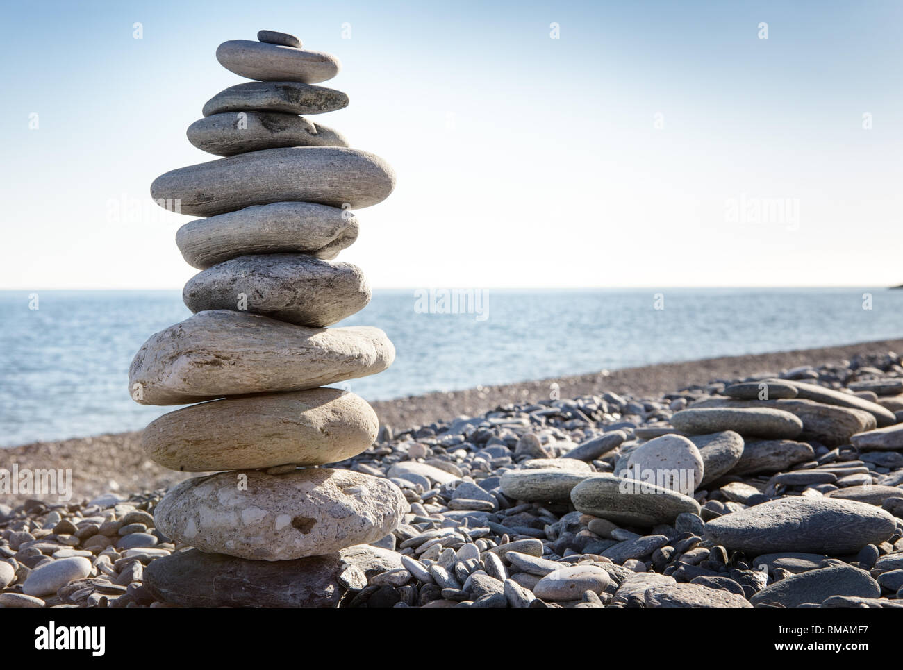 Rock balancing or stone balancin, naturally balanced on a beach with ...