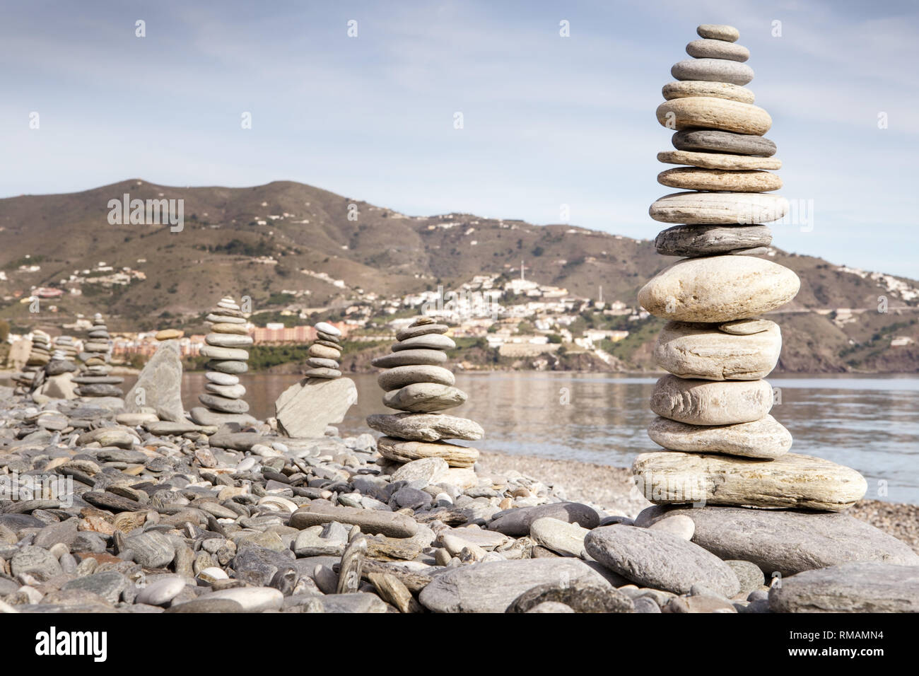 Rock balancing or stone balancin, naturally balanced on a beach with ...