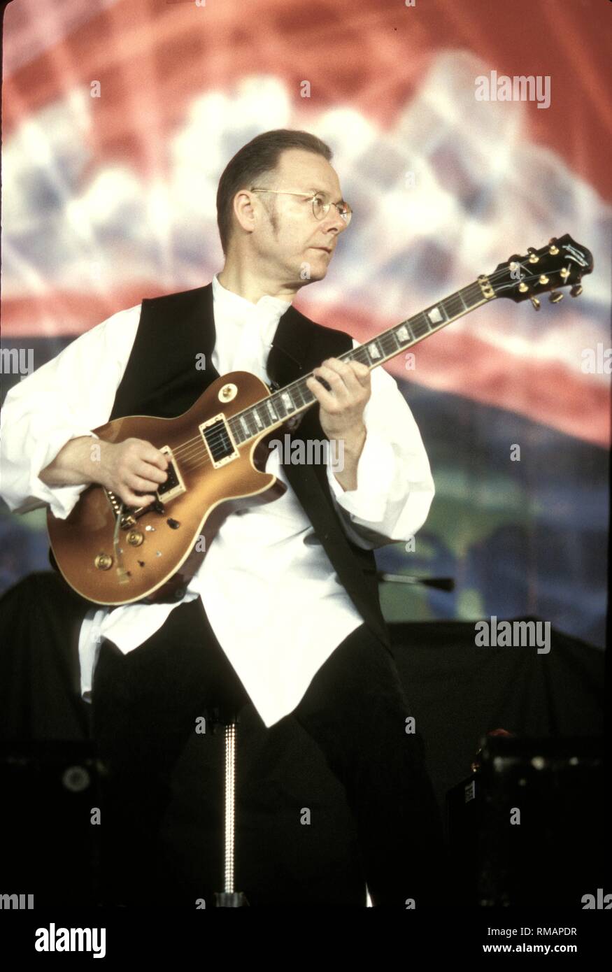 King Crimson founder Robert Fripp is shown performing on stage during a ...