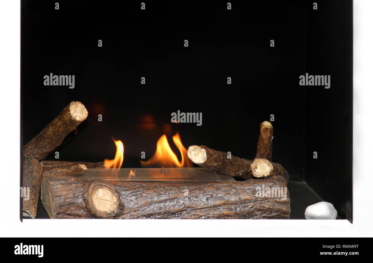Wooden logs burning in fire inside retro fireplace Stock Photo - Alamy