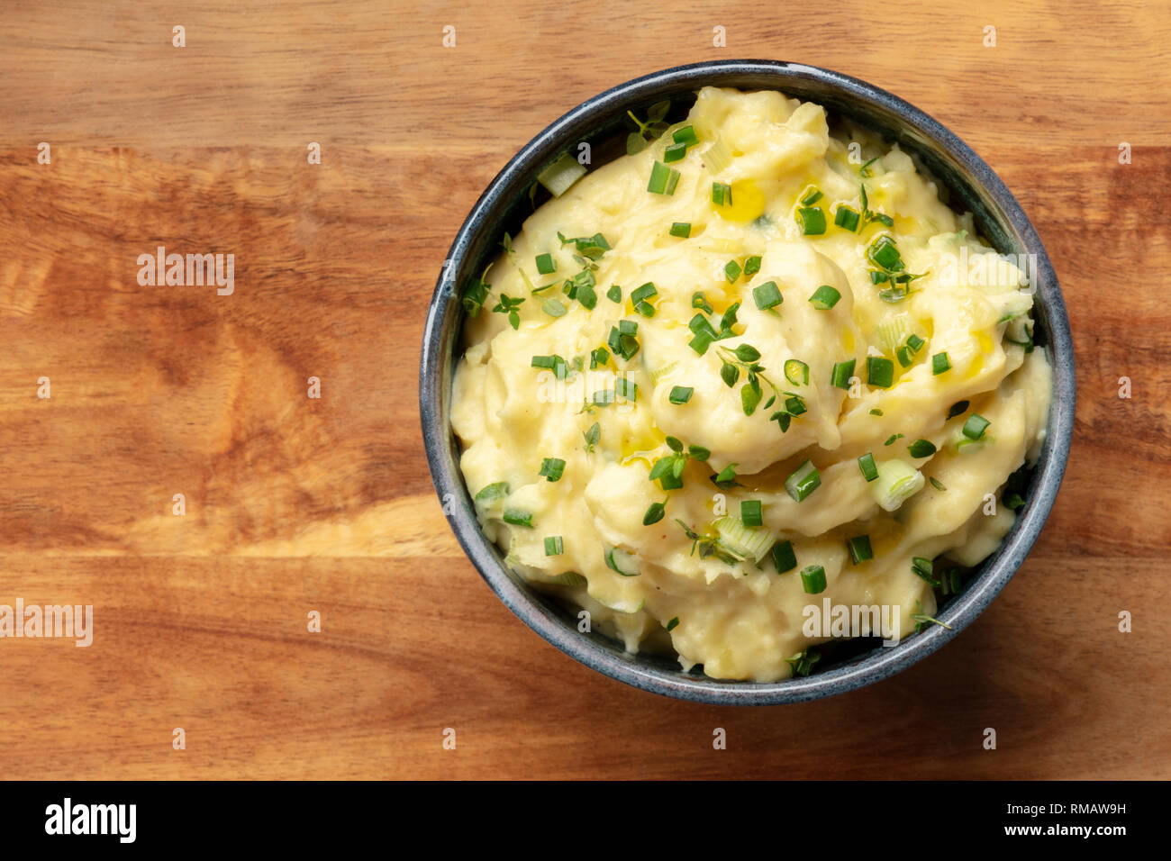 Pomme puree, a bowl of mashed potatoes with scallions and thyme, shot ...