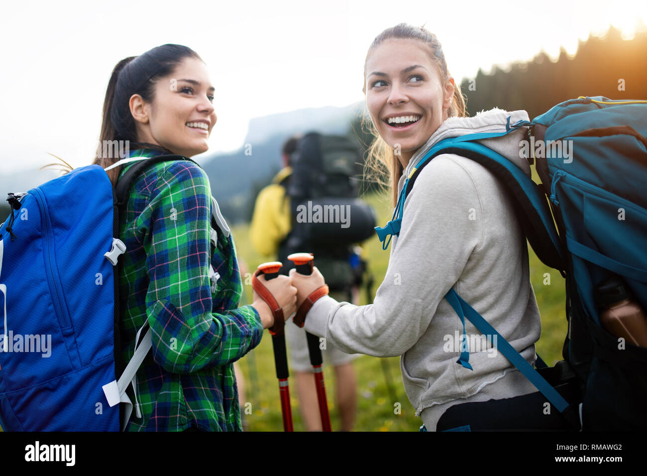 Hiking with friends is so fun. Group of young people with backpacks ...