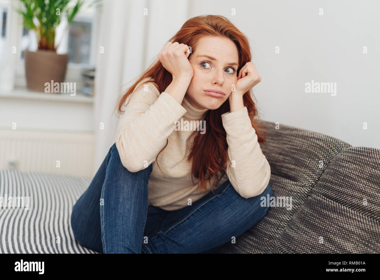Woman glum sofa hi-res stock photography and images - Alamy
