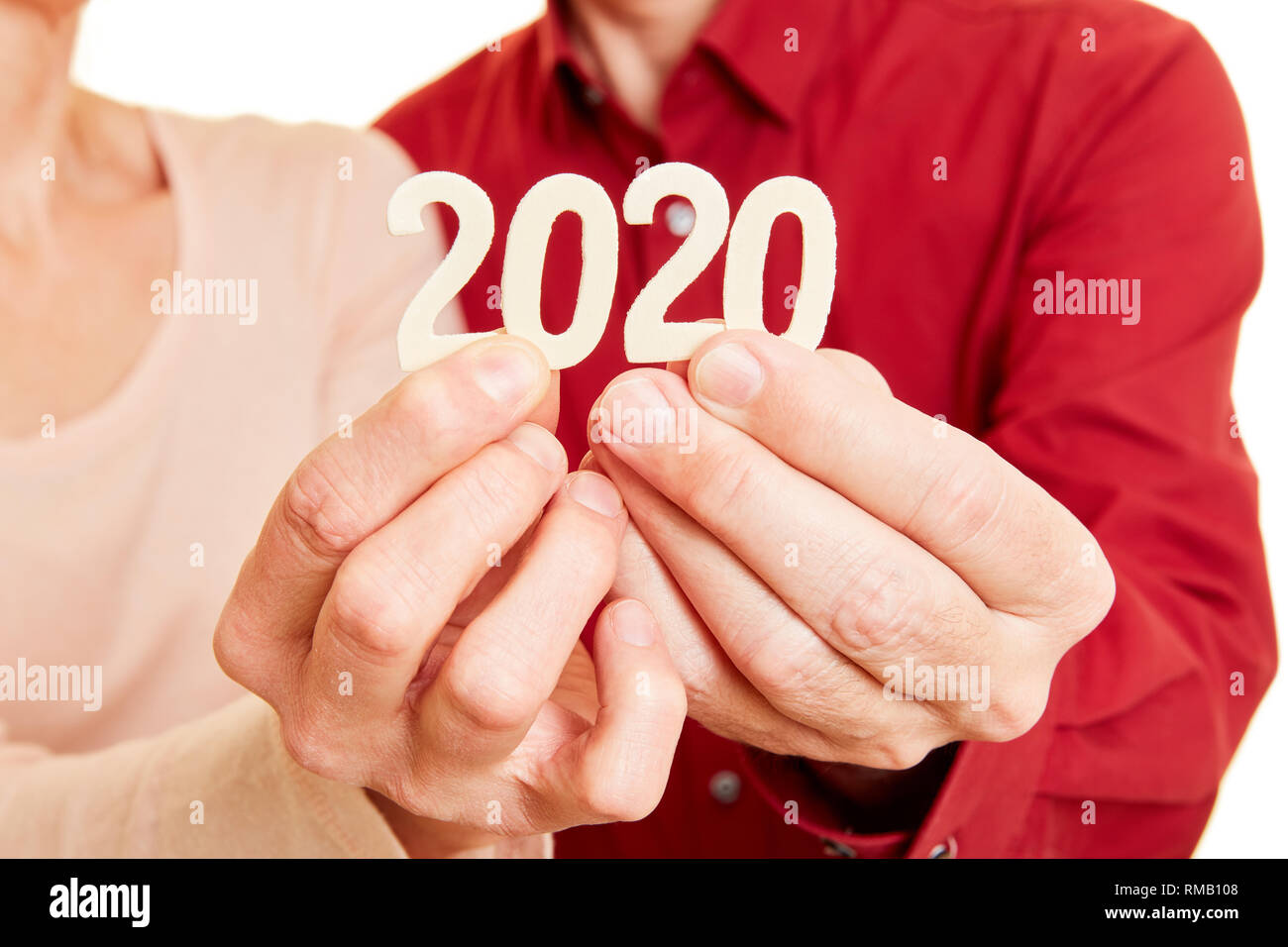Two seniors hands show the year 2020 as a number Stock Photo - Alamy