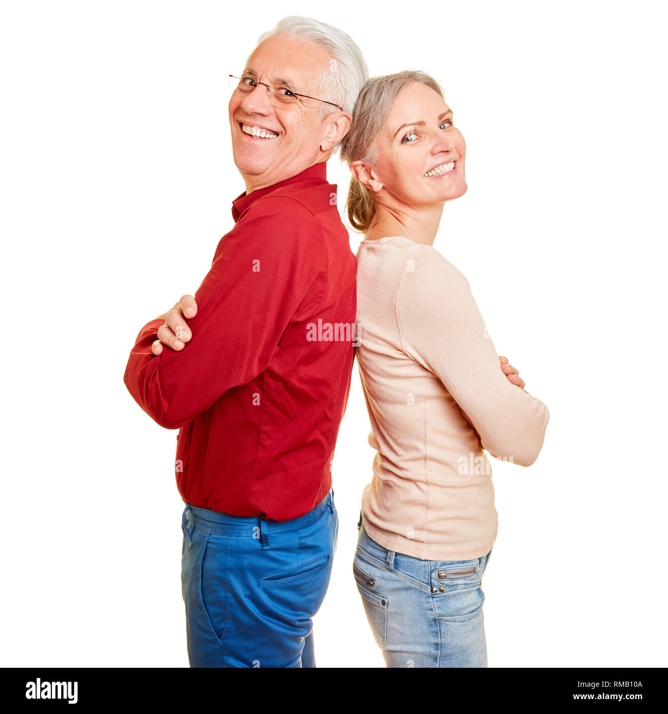 Happy seniors couple leaning back to back with crossed arms Stock Photo ...