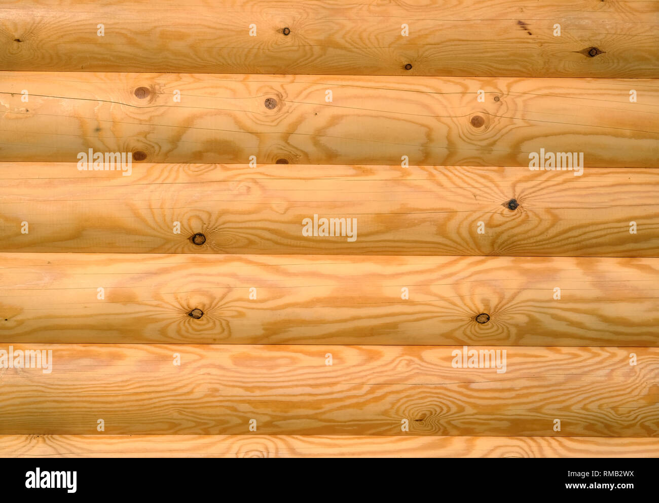 Background of horizontal hewed smooth painted wooden logs close up ...