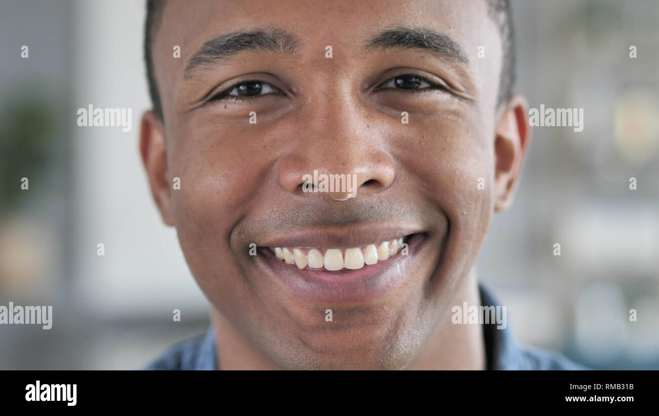 Smiling Face of Young African Man Stock Photo - Alamy