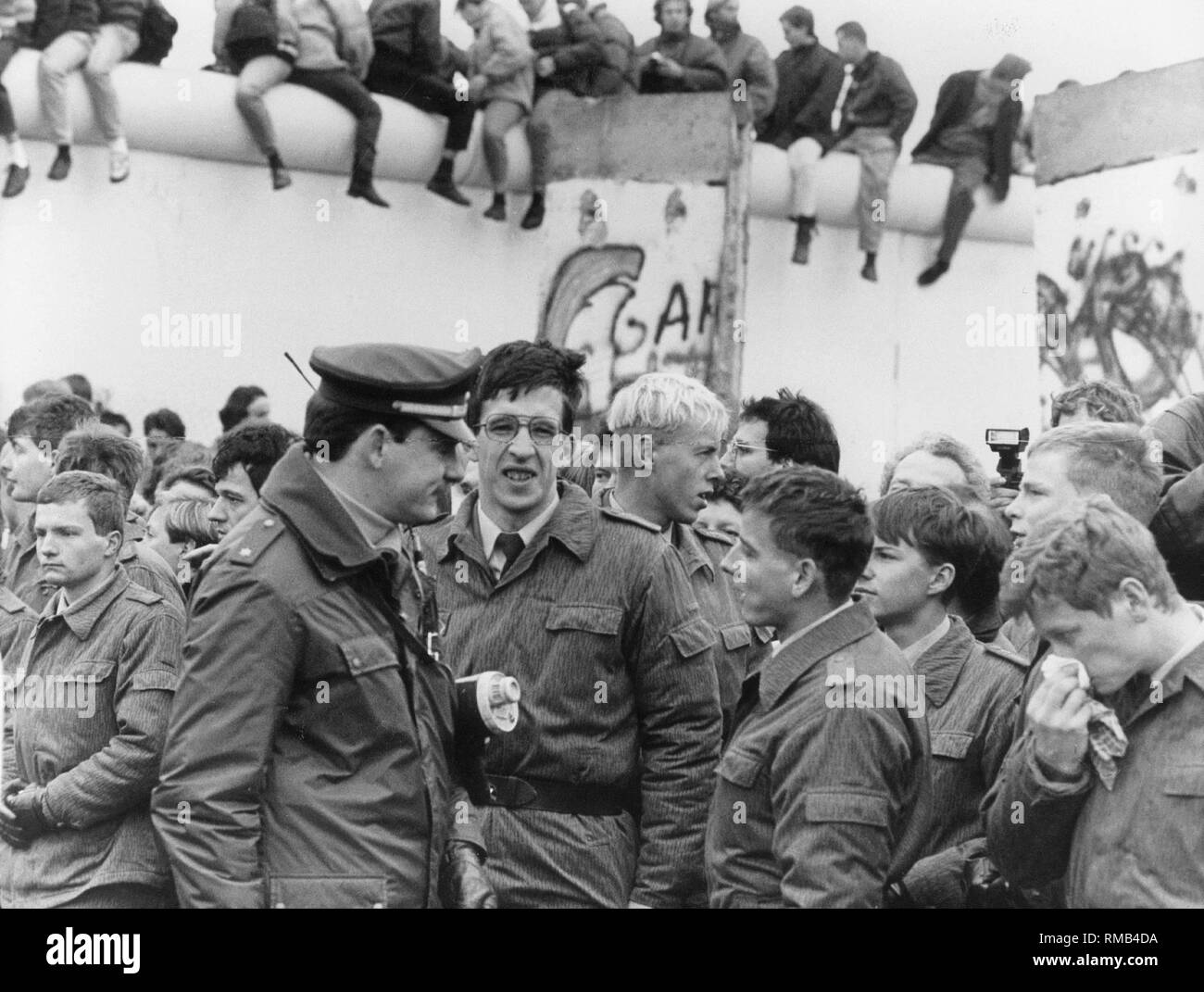 A West Berlin police officer talks with his East German counterparts ...