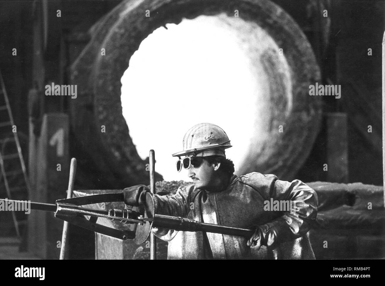 Smelter with oxygen lance at the electric furnace during charging with ...