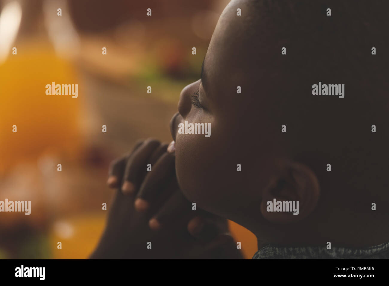 African boy praying hi-res stock photography and images - Alamy