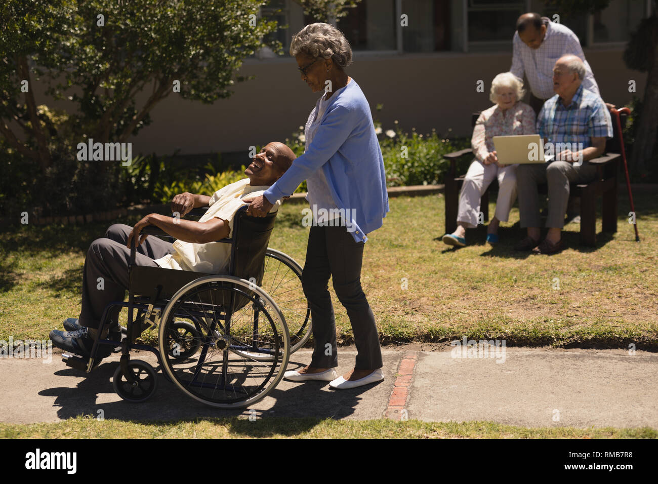 Man pushing woman wheelchair hi-res stock photography and images - Alamy