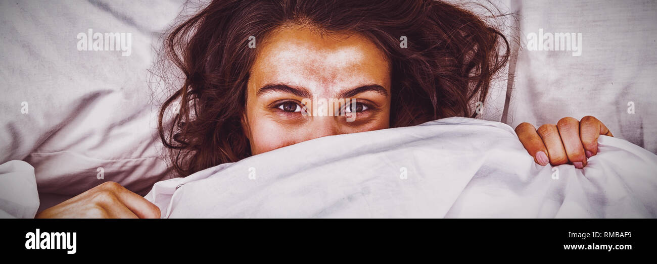 Woman hiding under blanket hi-res stock photography and images - Alamy