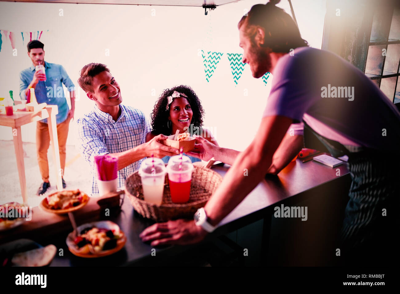 Waiter serving snacks to customers Stock Photo - Alamy